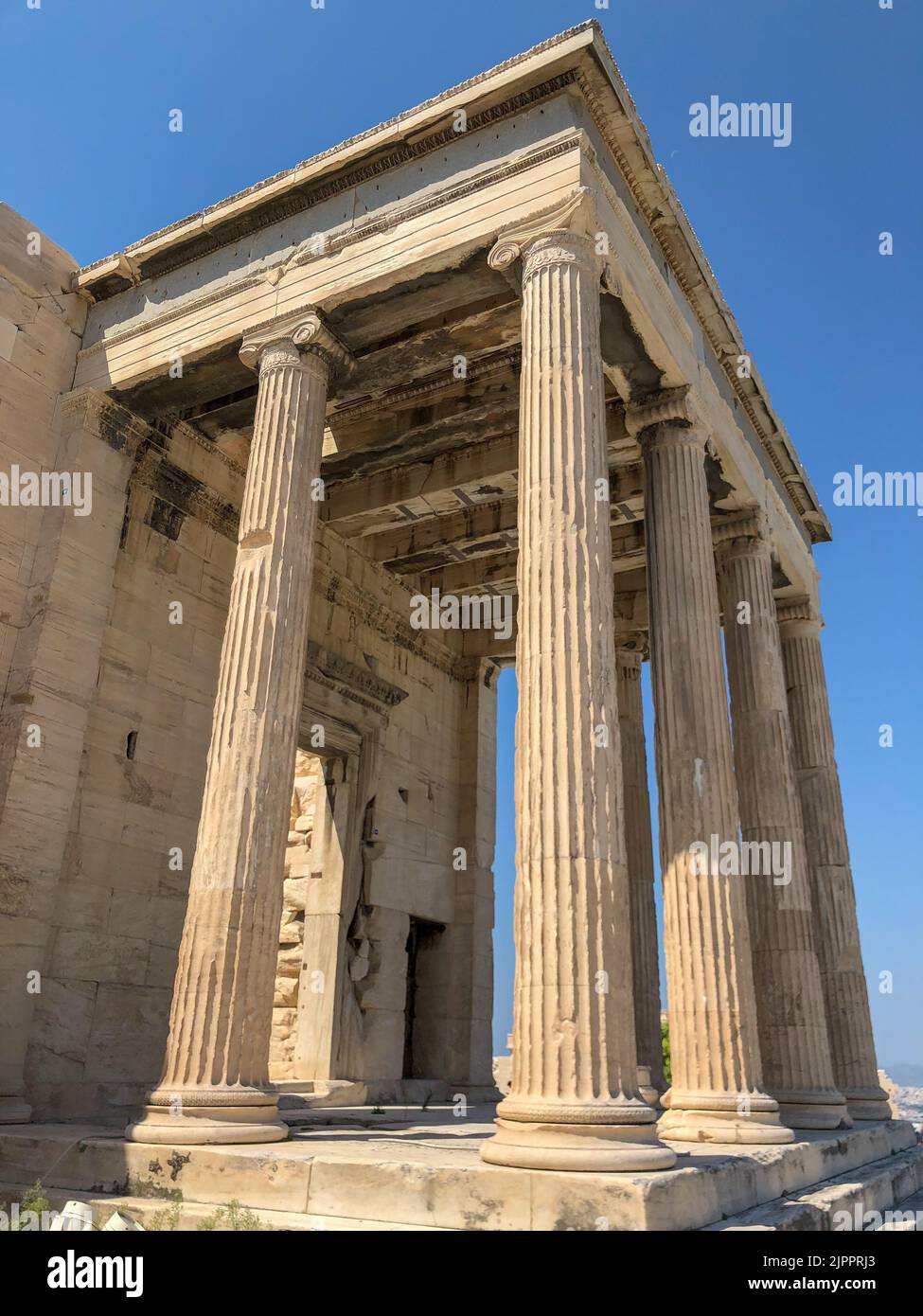 A vertical shot of the Parthenon monument of ancient Greek architecture, one of the main temples ...