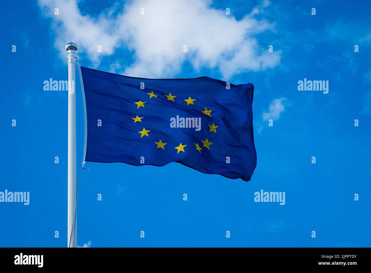 Flag of EU on blue sky background. European Union flag waving in wind ... Flag of EU on blue sky background. European Union flag waving in wind ...