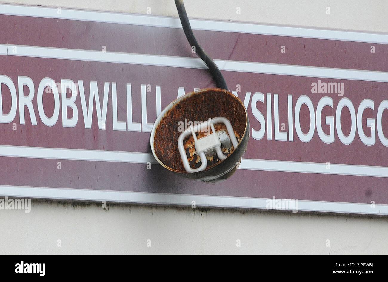 A RUSTING LIGHT HANGS ACROSS THE FAMOUS SIGN AT THE DELAPIDATED STATION ...