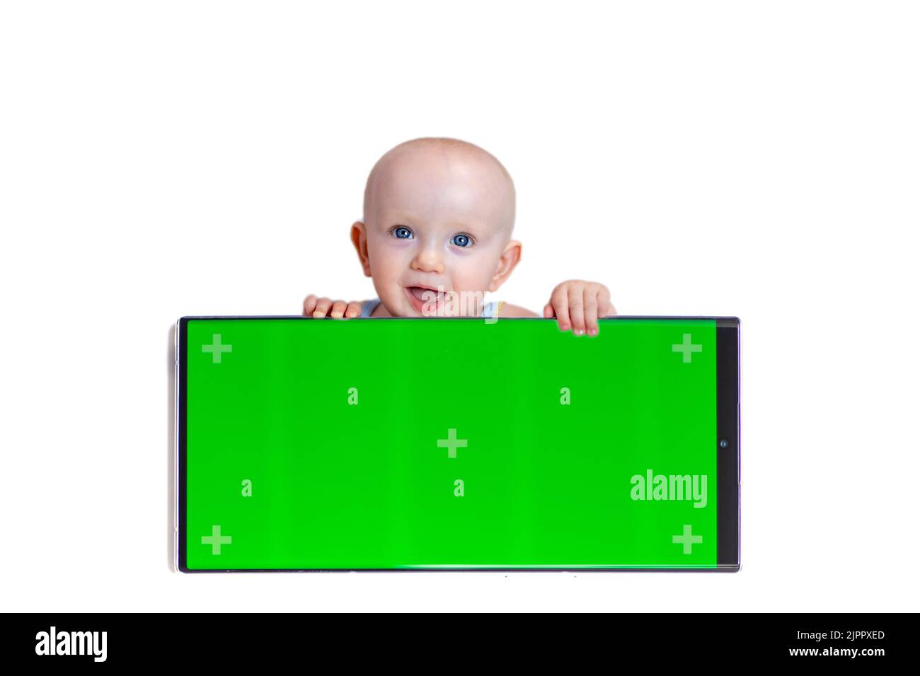 little cute baby peeking out from behind smartphone with green screen ...