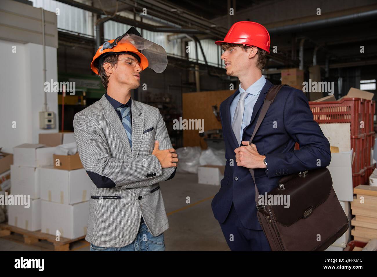two engineers at the construction site discuss the work to be done ...