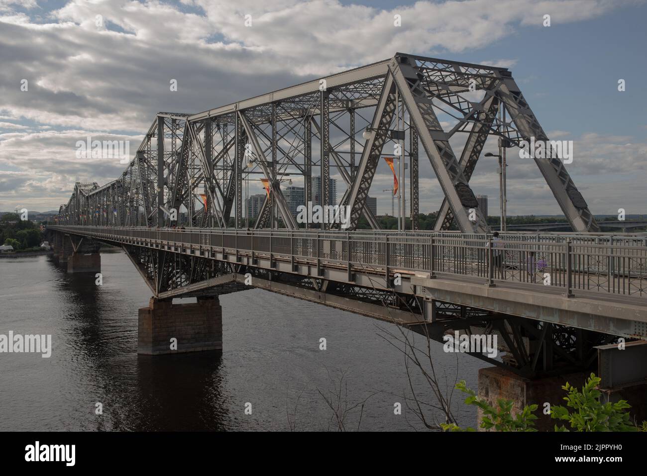 The Alexandra Bridge in Canada with gray clouds above spanning the ...