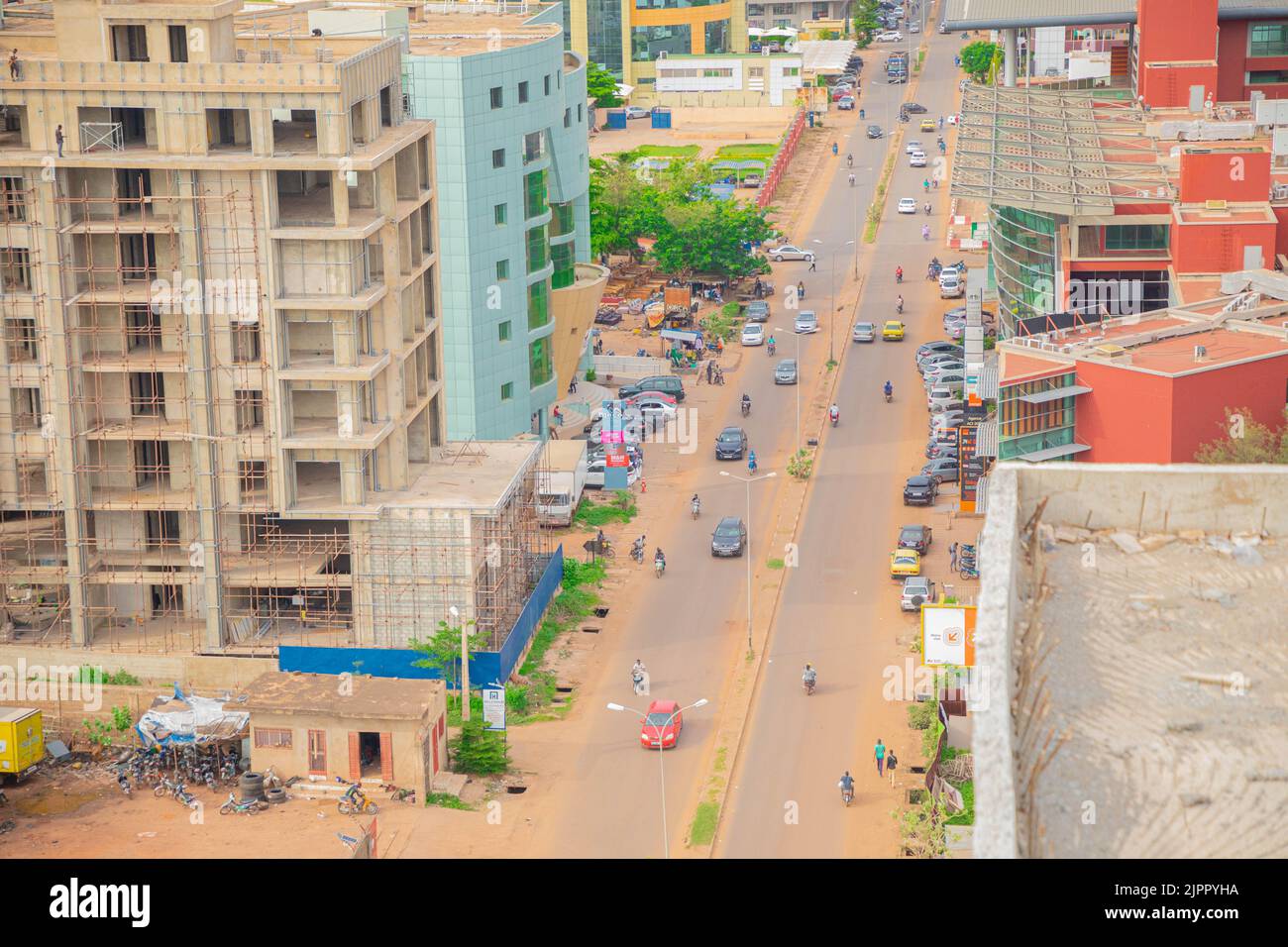 A busy street in the Republic of Mali in West Africa with cars,cyclists ...