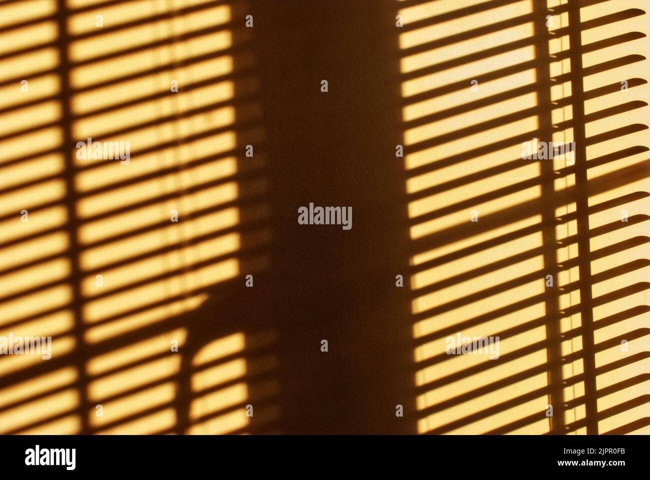 Shadows and light on the wall from the sun shining through window ...