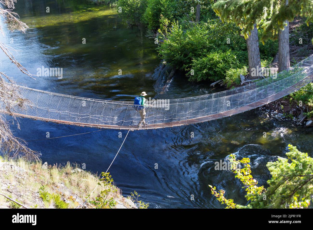 Suspension bridge over mountain river hi-res stock photography and ...