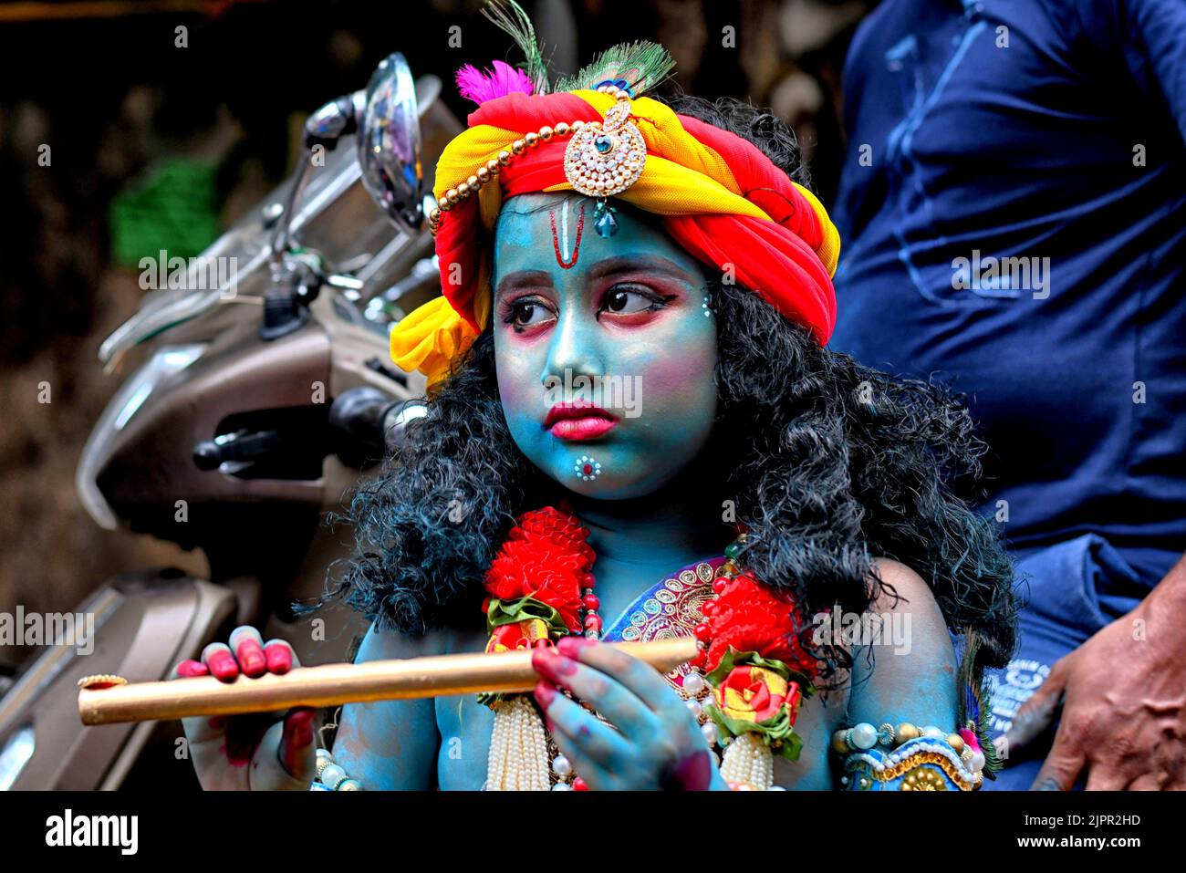A child with a colored face as lord Krishna seen during 'Janmashtami ...
