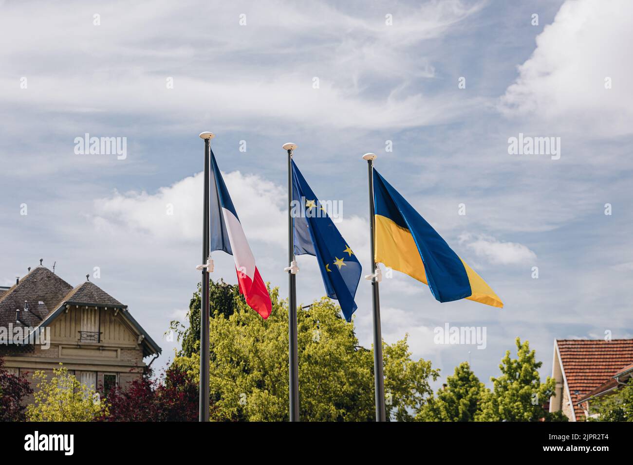 An outdoor view of waving French, European Union, and Ukrainian Flags ...