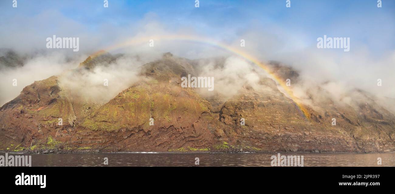 A rainbow over the rugged cliffs of Guadalupe Island in the Pacific ...