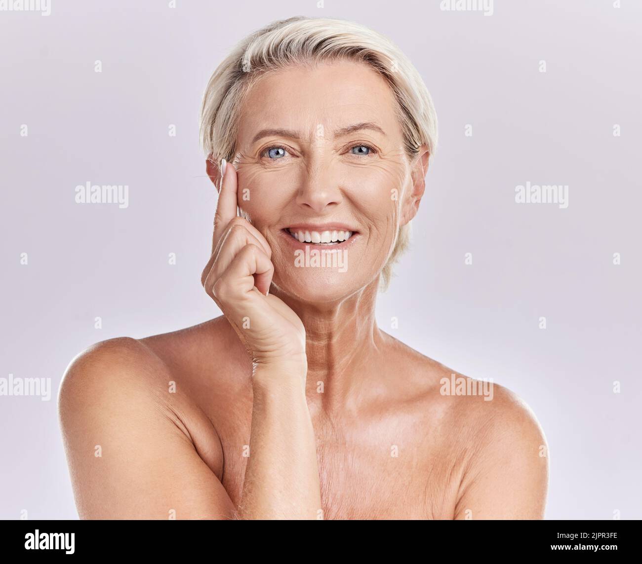 Senior woman applying beauty sunscreen, face cream or moisturizing ...