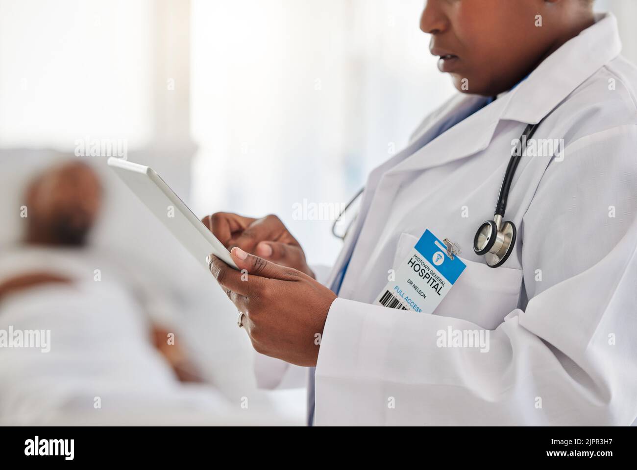 Health, insurance and medicine with a doctor typing on a digital tablet ...
