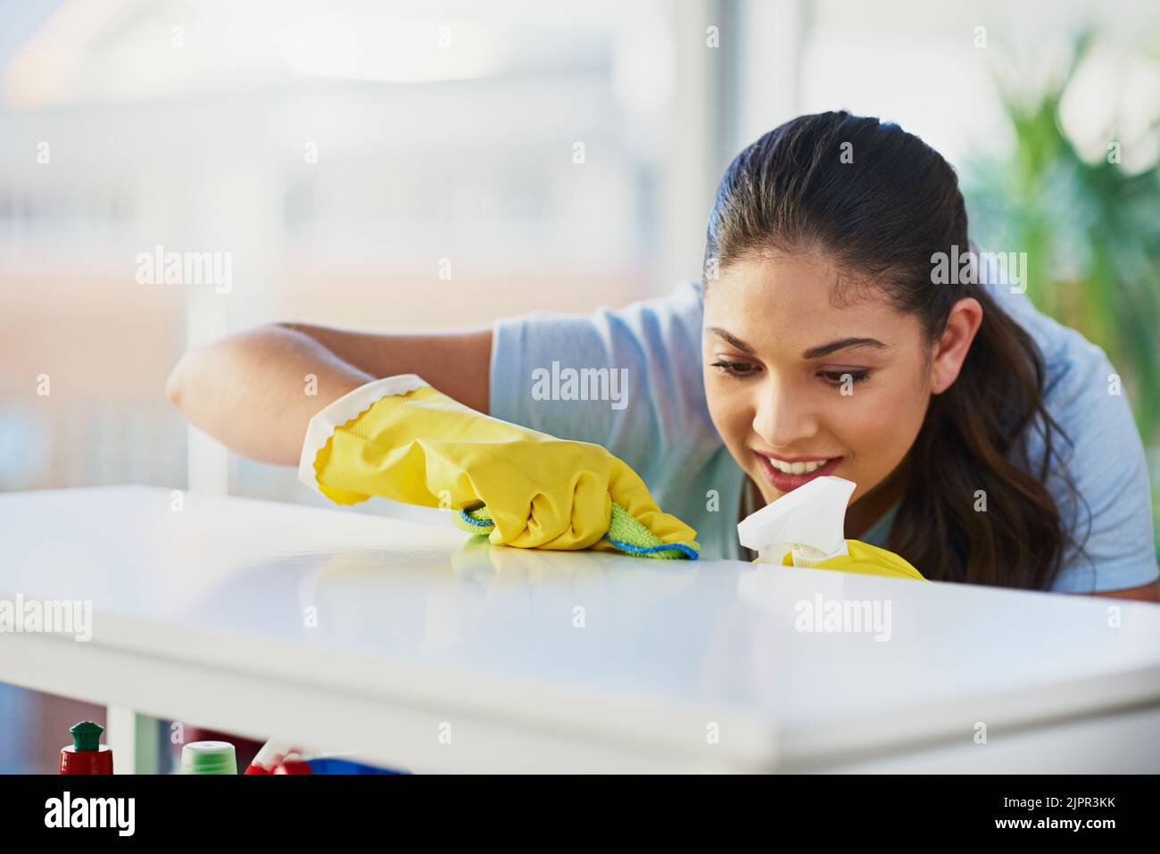 I will not miss a spot. a woman doing her daily chores at home Stock ...