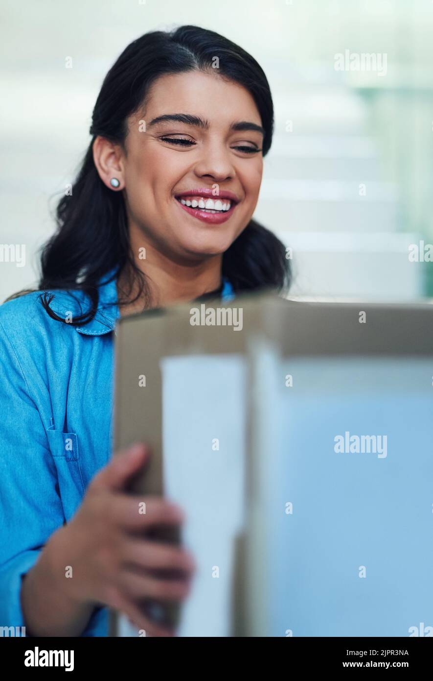 Right on time. a young woman receiving a package from the courier Stock ...
