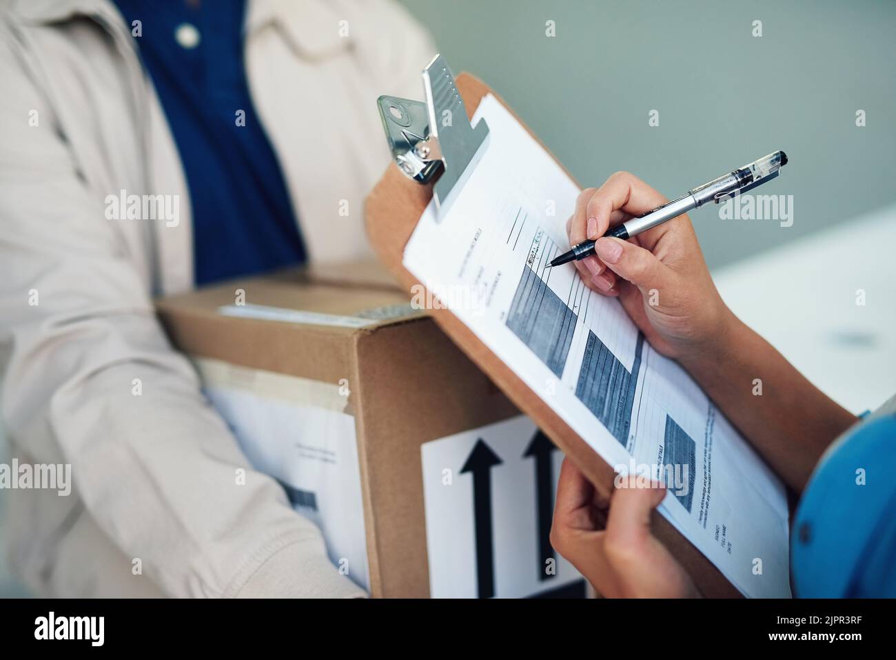 Signing for a parcel hi-res stock photography and images - Alamy