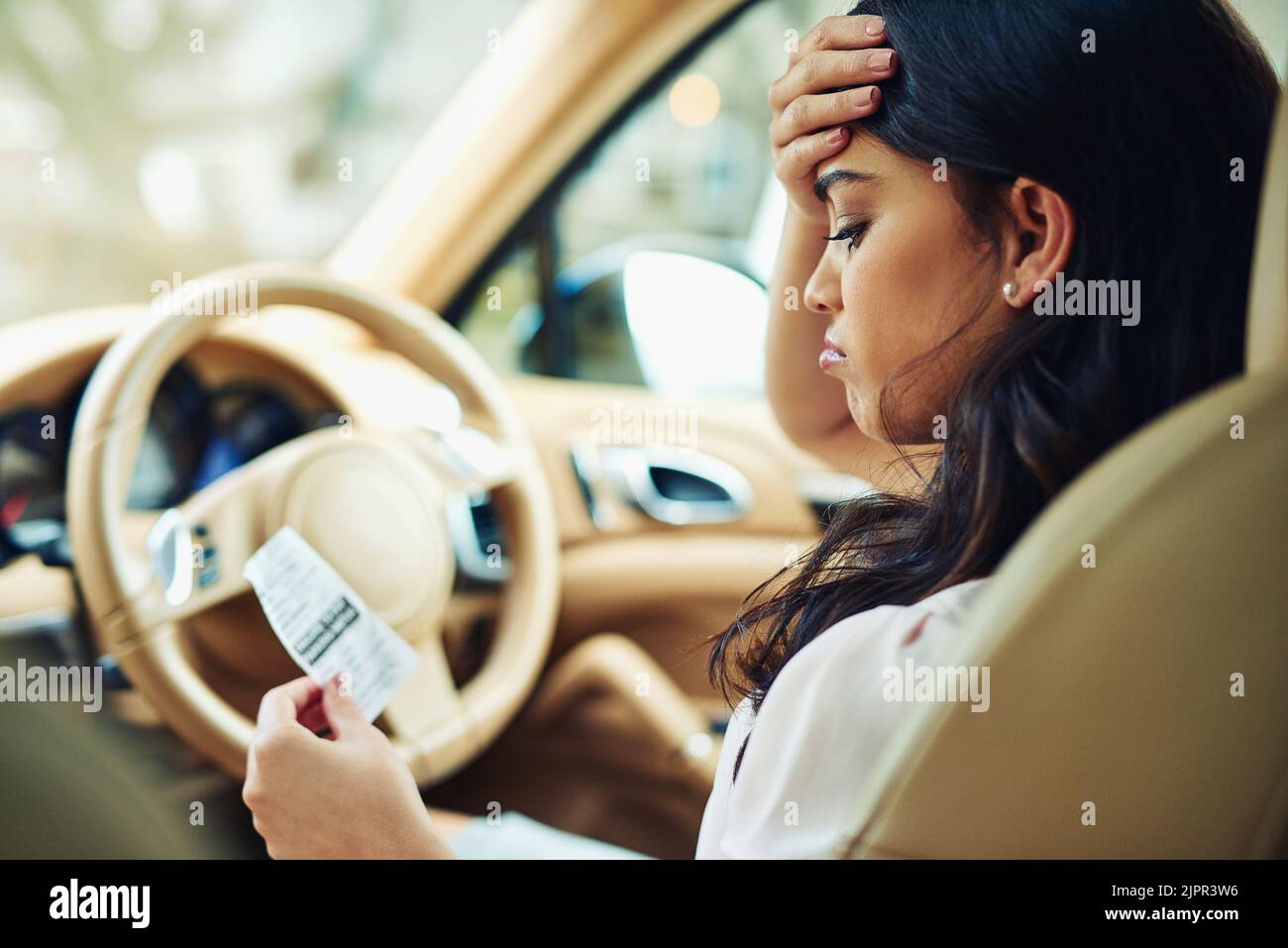 Oh no not a parking ticket. an attractive young woman annoyed that she ...
