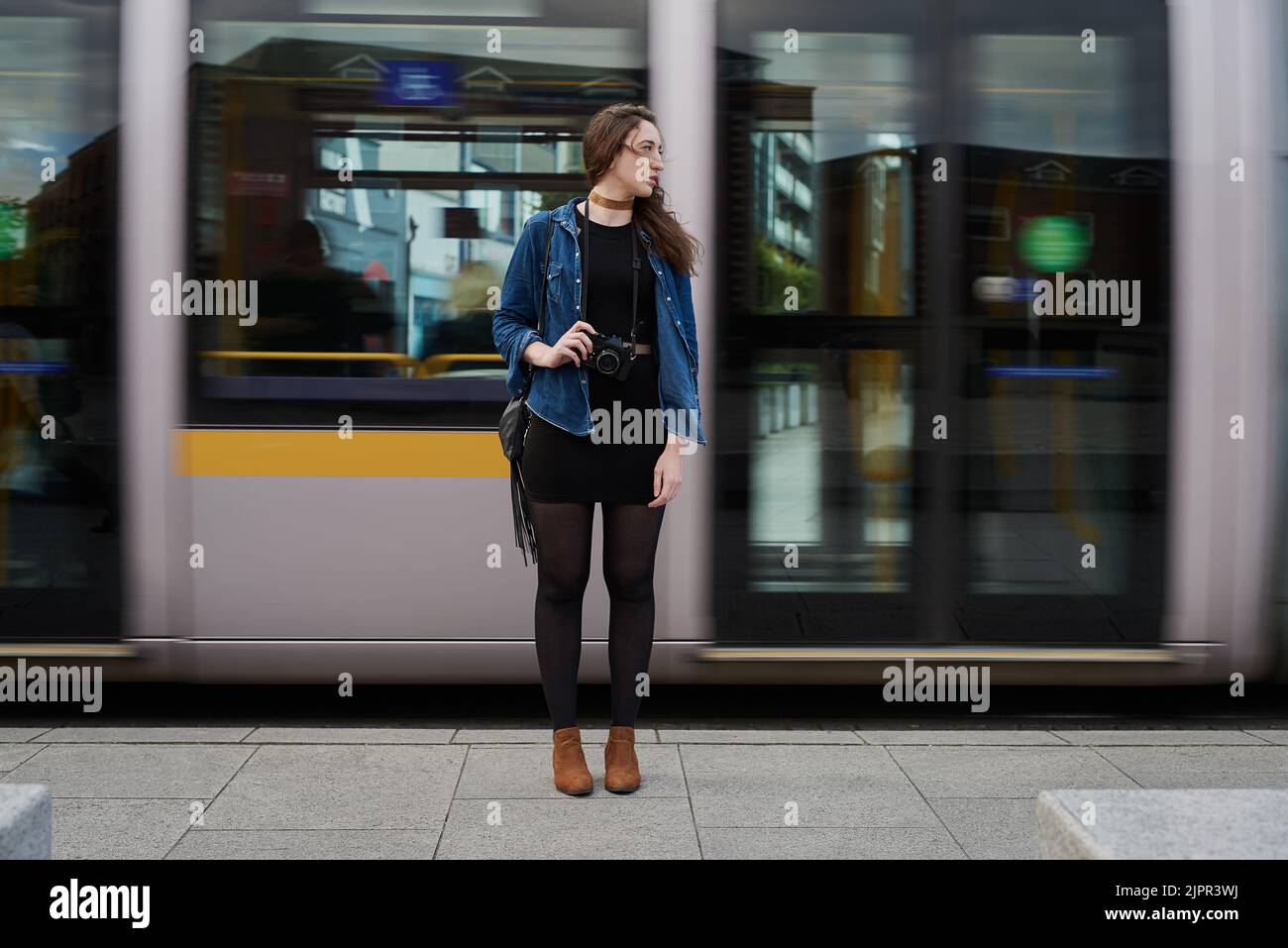 She goes everywhere by train. an attractive young female photographer ...