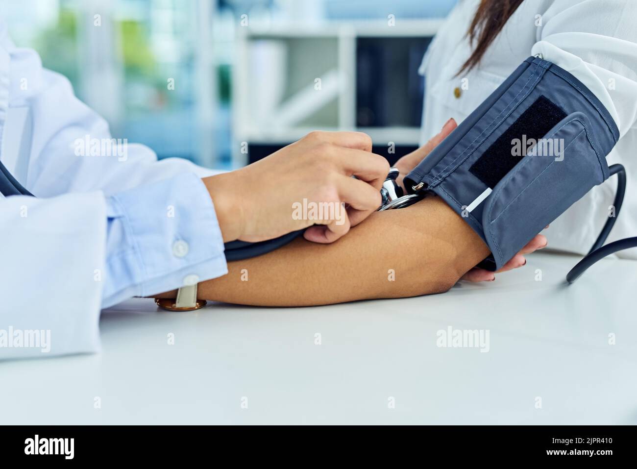 Female doctor checking blood pressure of a patient hi-res stock ...