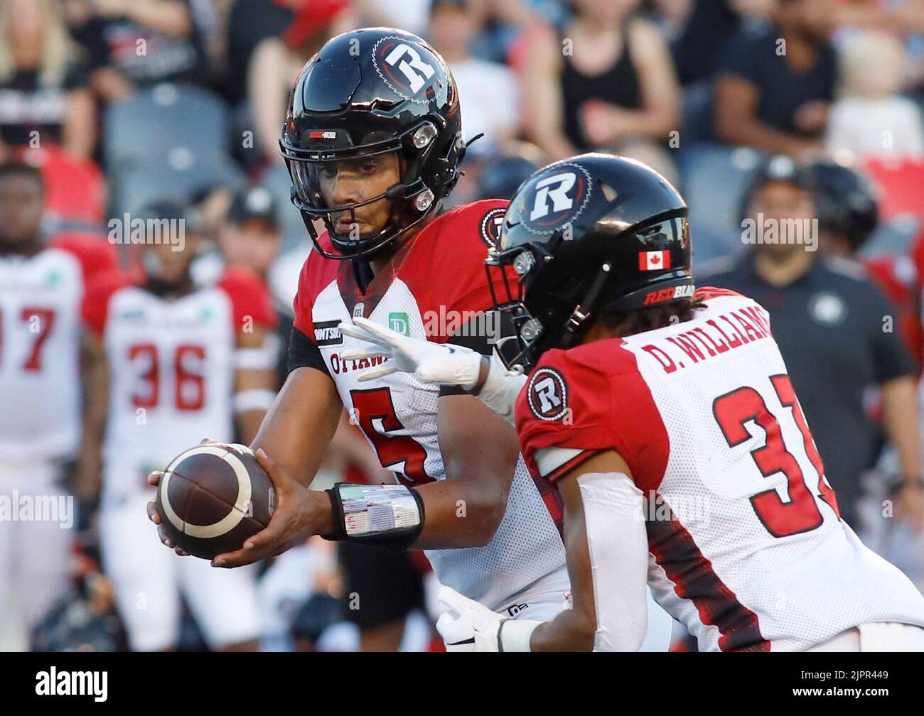 Ottawa Redblacks quarterback Caleb Evans (5) hands the ball to ...