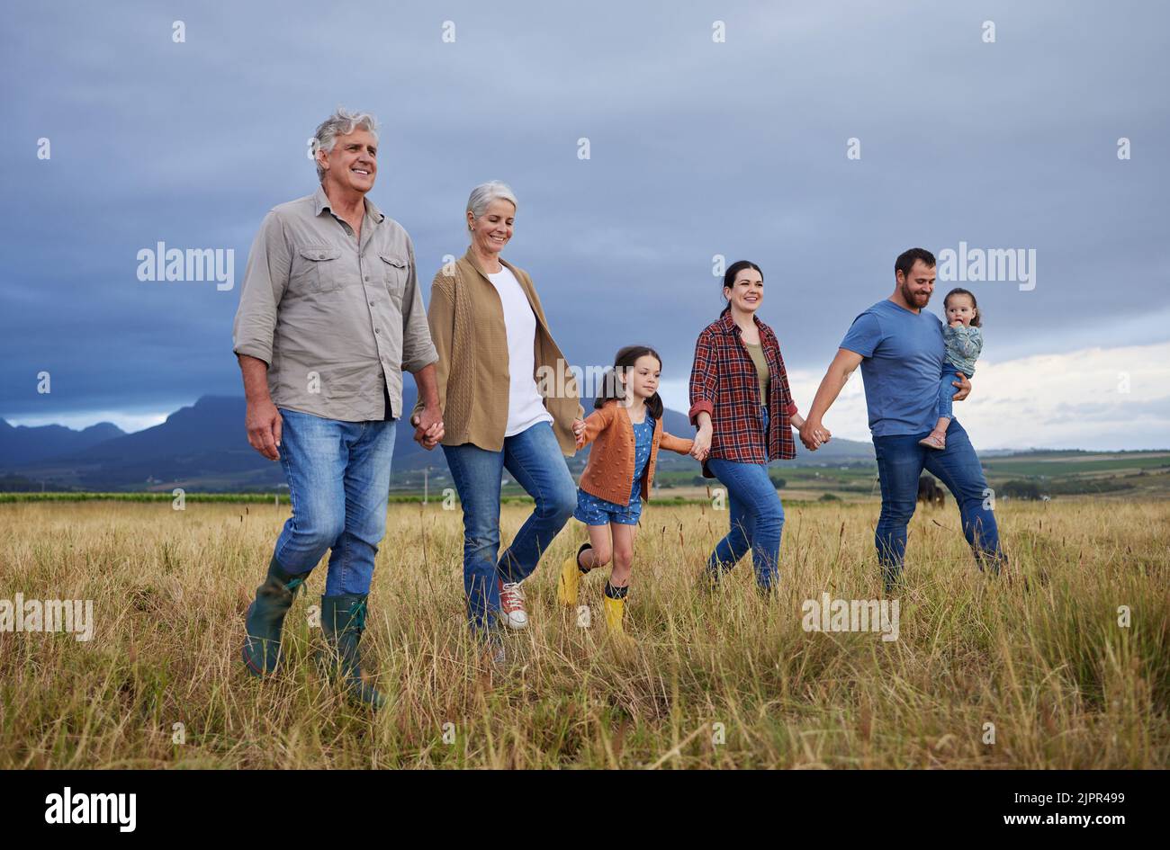 Big happy family walking on field, meadow and countryside in nature to ...
