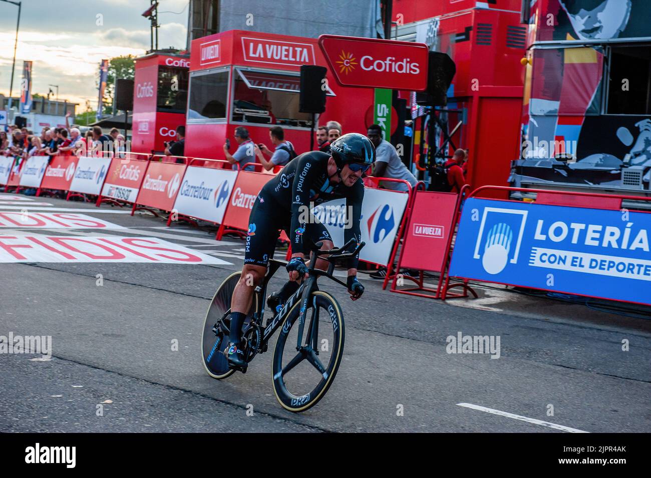 A cyclist from DSM team is seen crossing alone the finish line. La ...