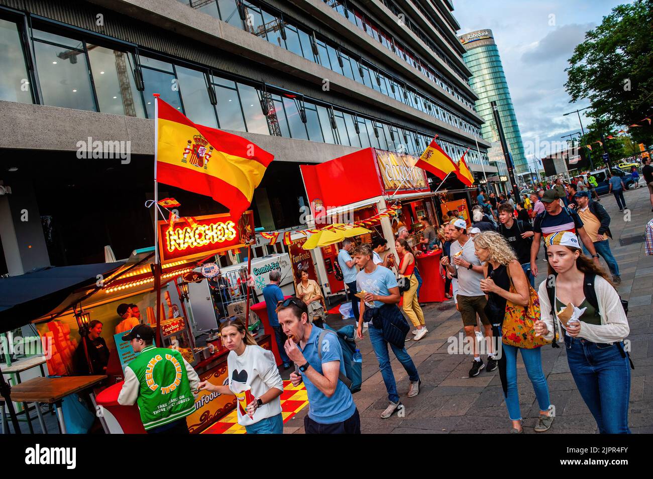 People walk past a Spanish food market around the circuit of La Vuelta ...