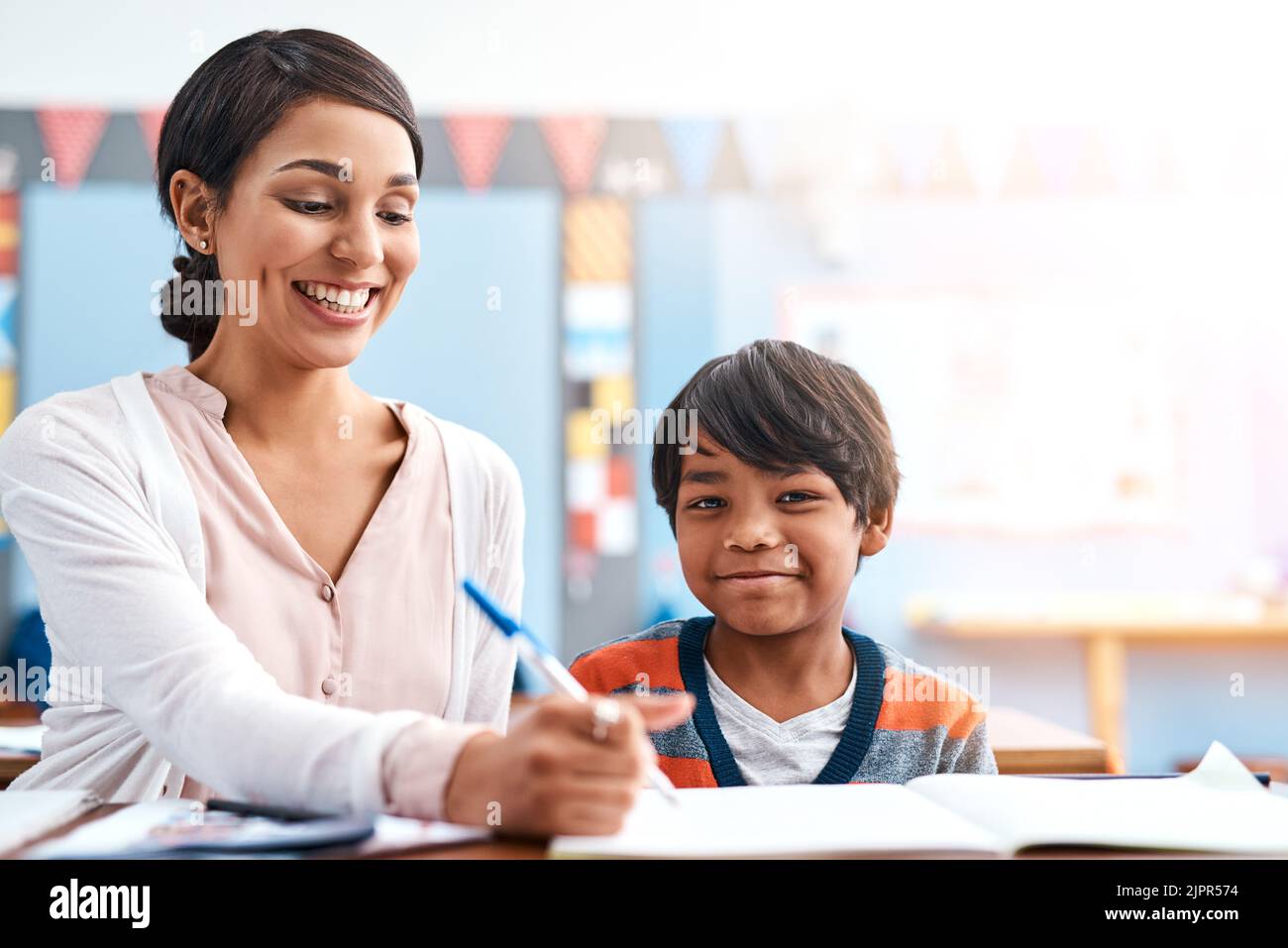 This one is correct. a cheerful young female teacher helping a student ...