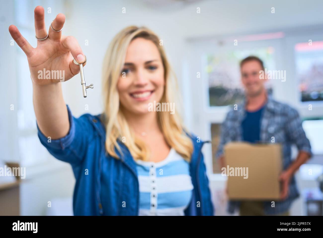The key to our new nest. Portrait of a young woman holding the key to ...