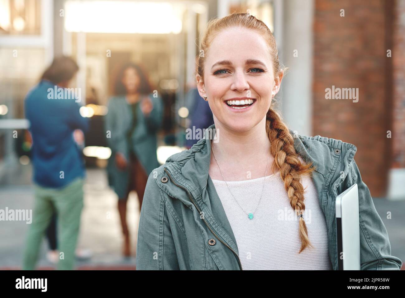 All about that college life. Portrait of a happy young woman standing ...