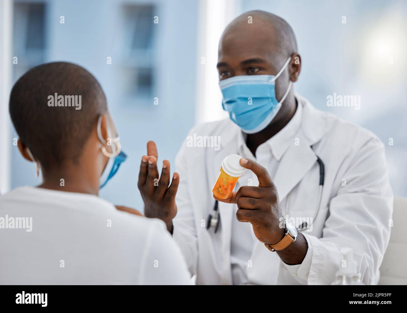 Doctor with mask, covid patient and pills or medicine, drugs and ...