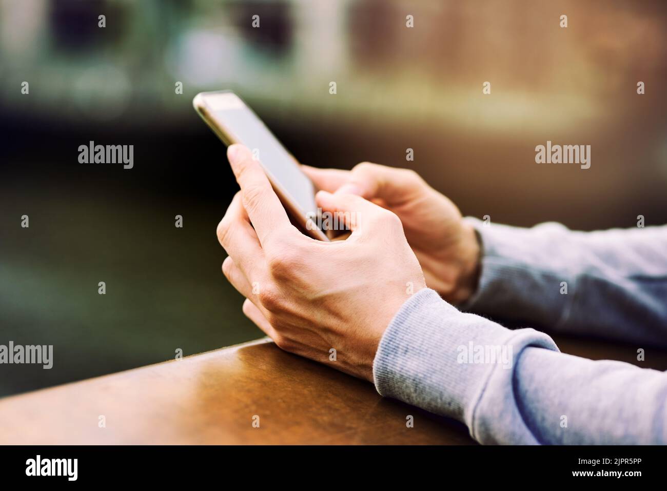 Everything he needs in one small device. a man using his mobile phone ...
