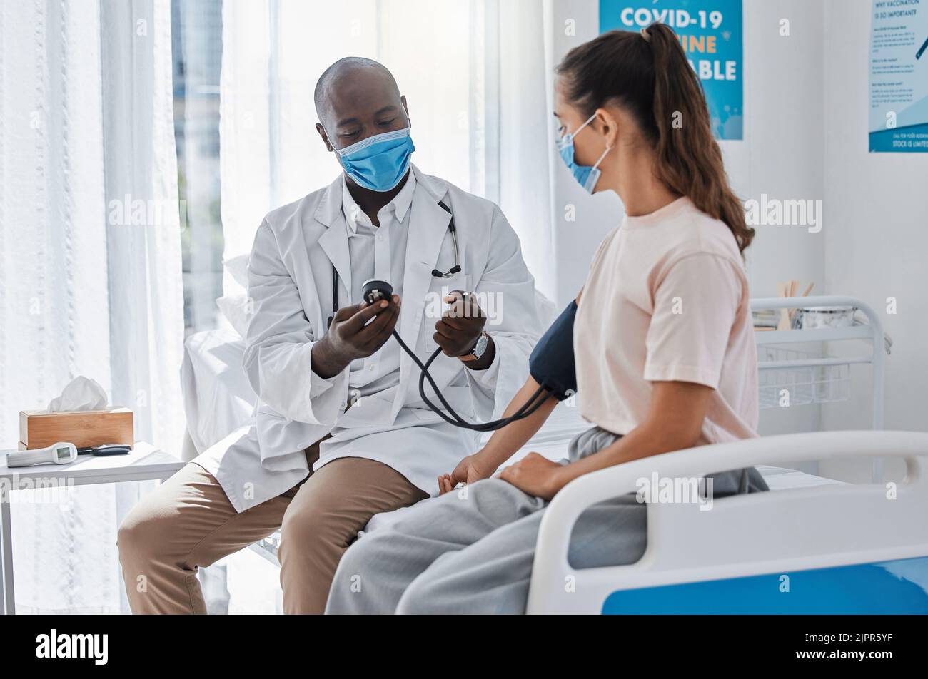 Doctor, blood pressure and healthcare medic checking womans ...