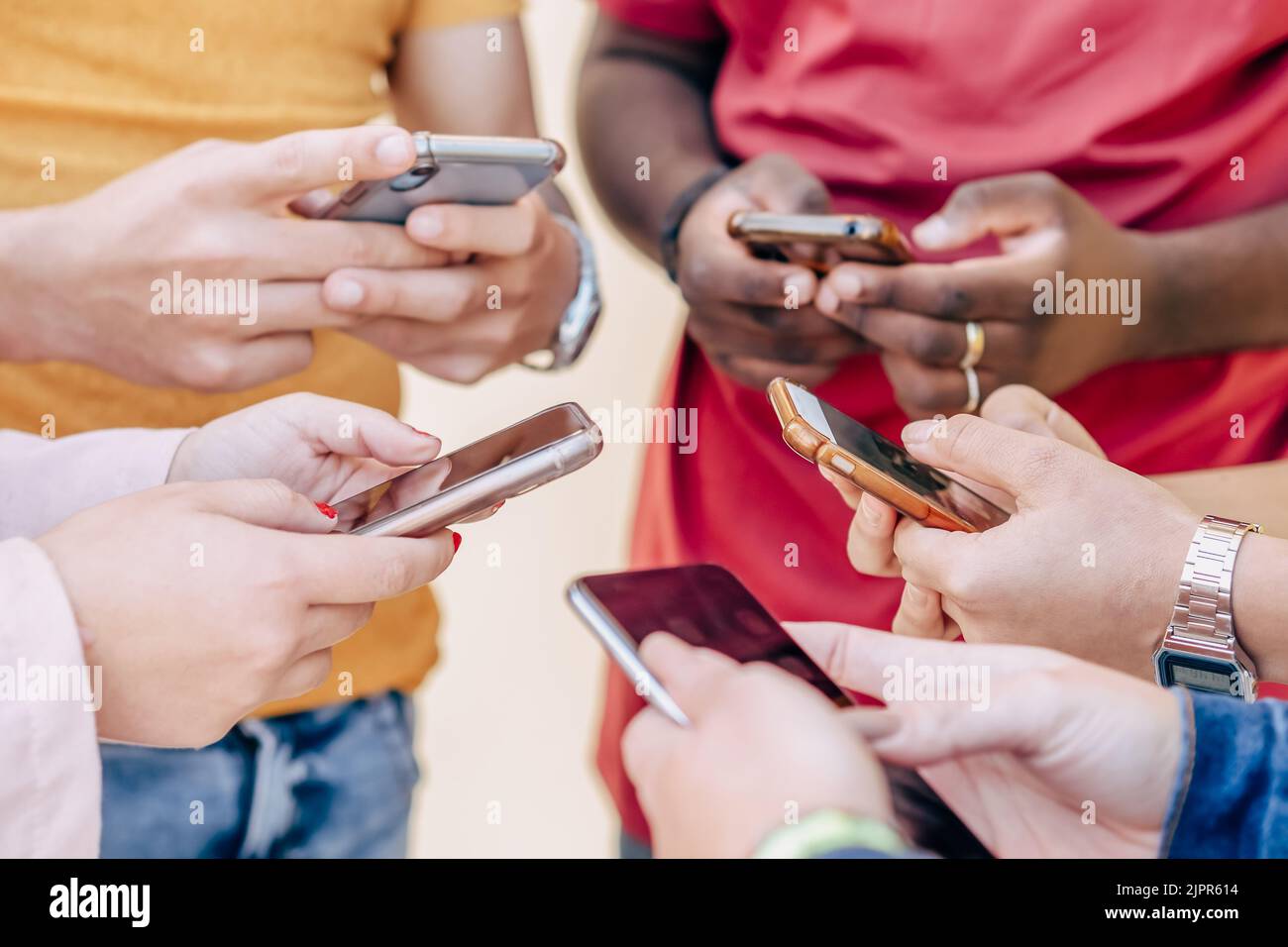 Group of young people using their phones outdoors. Education, technology and happiness concept ...