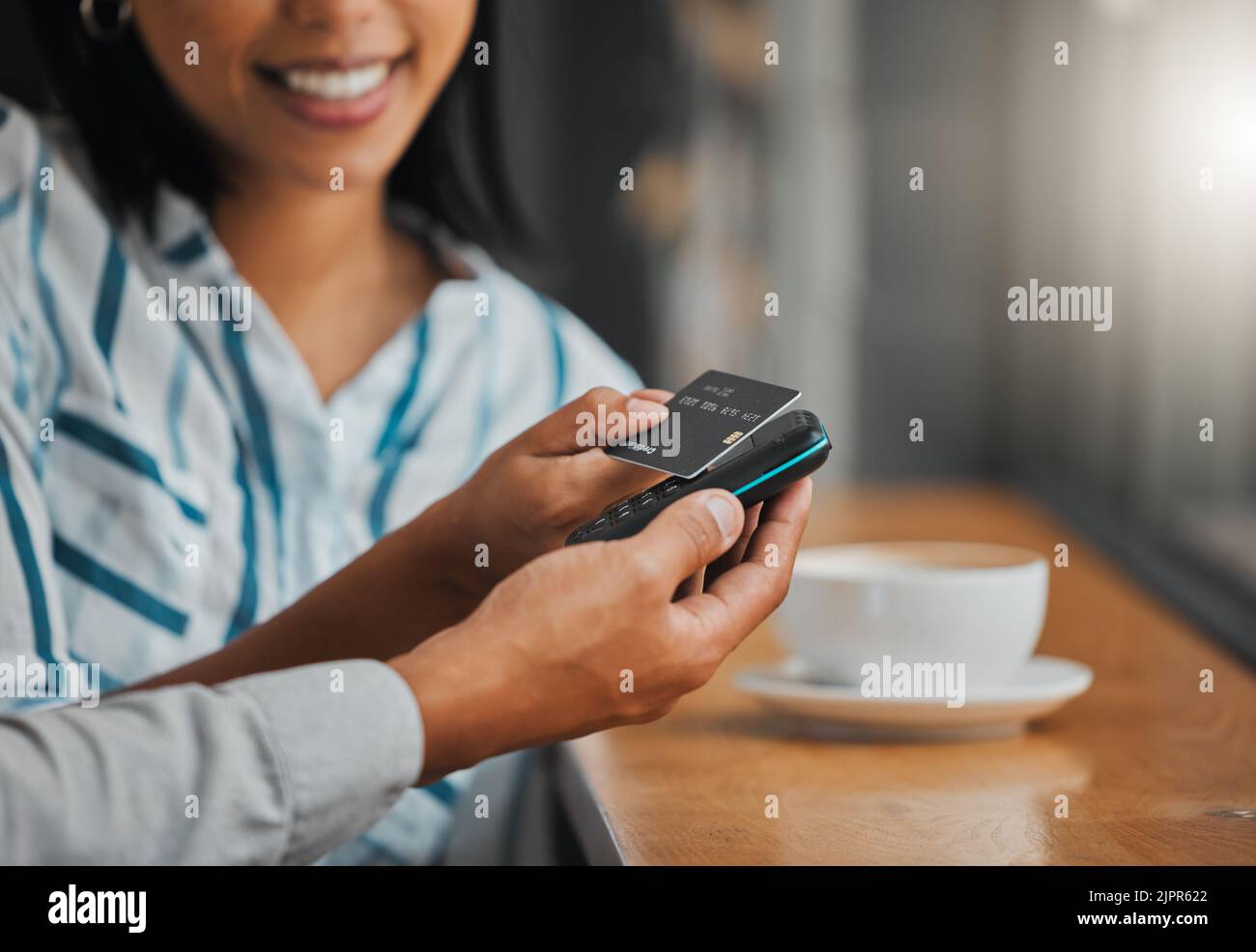 Hands paying bill with credit card payment for coffee or tea at cafe ...