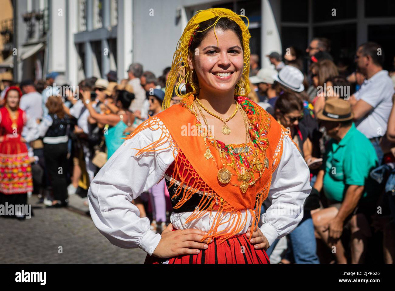 Portrait of a woman wearing the traditional red costume. More than half ...