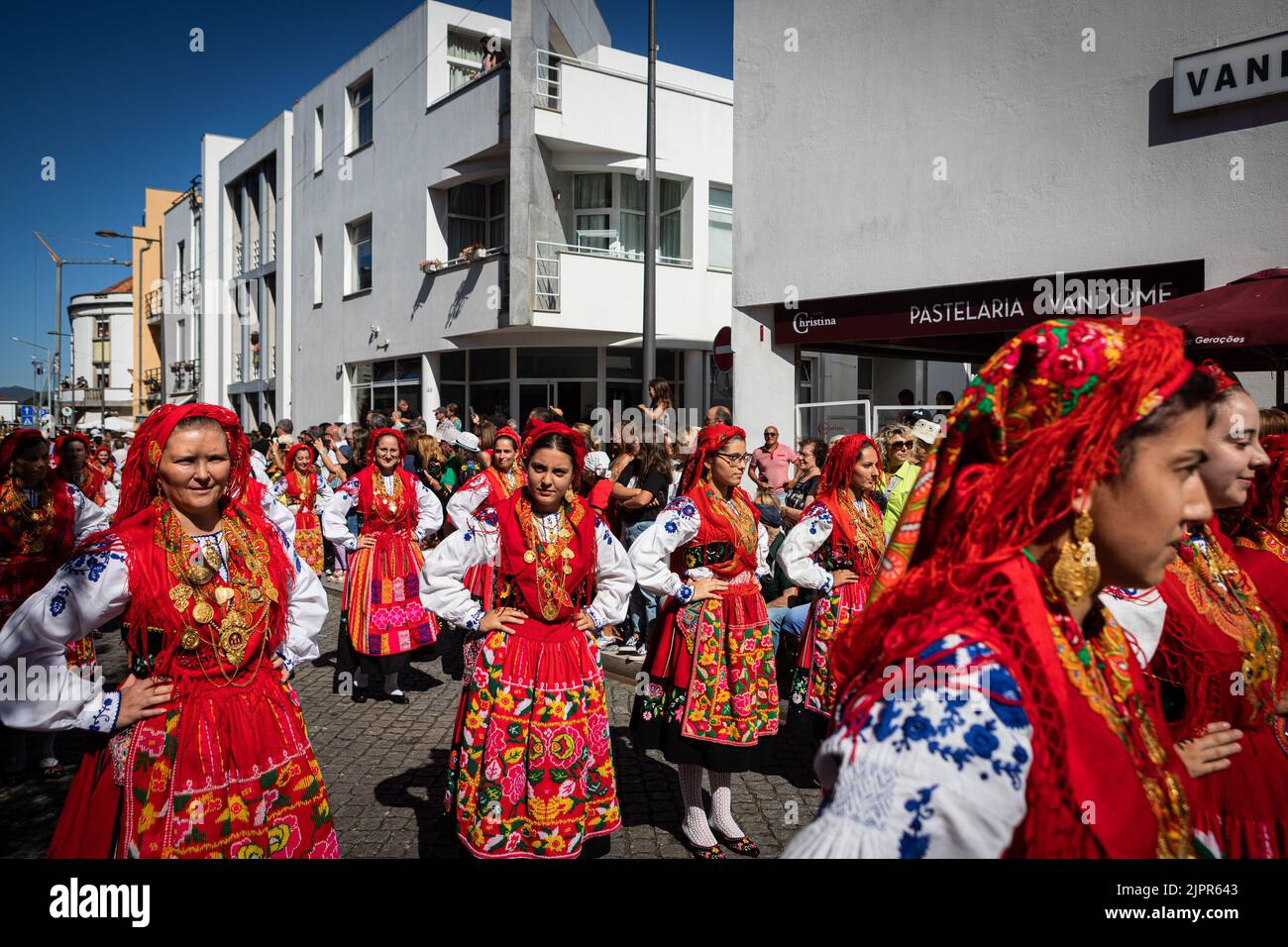 Women are seen walking the parade in traditional costumes. More than ...
