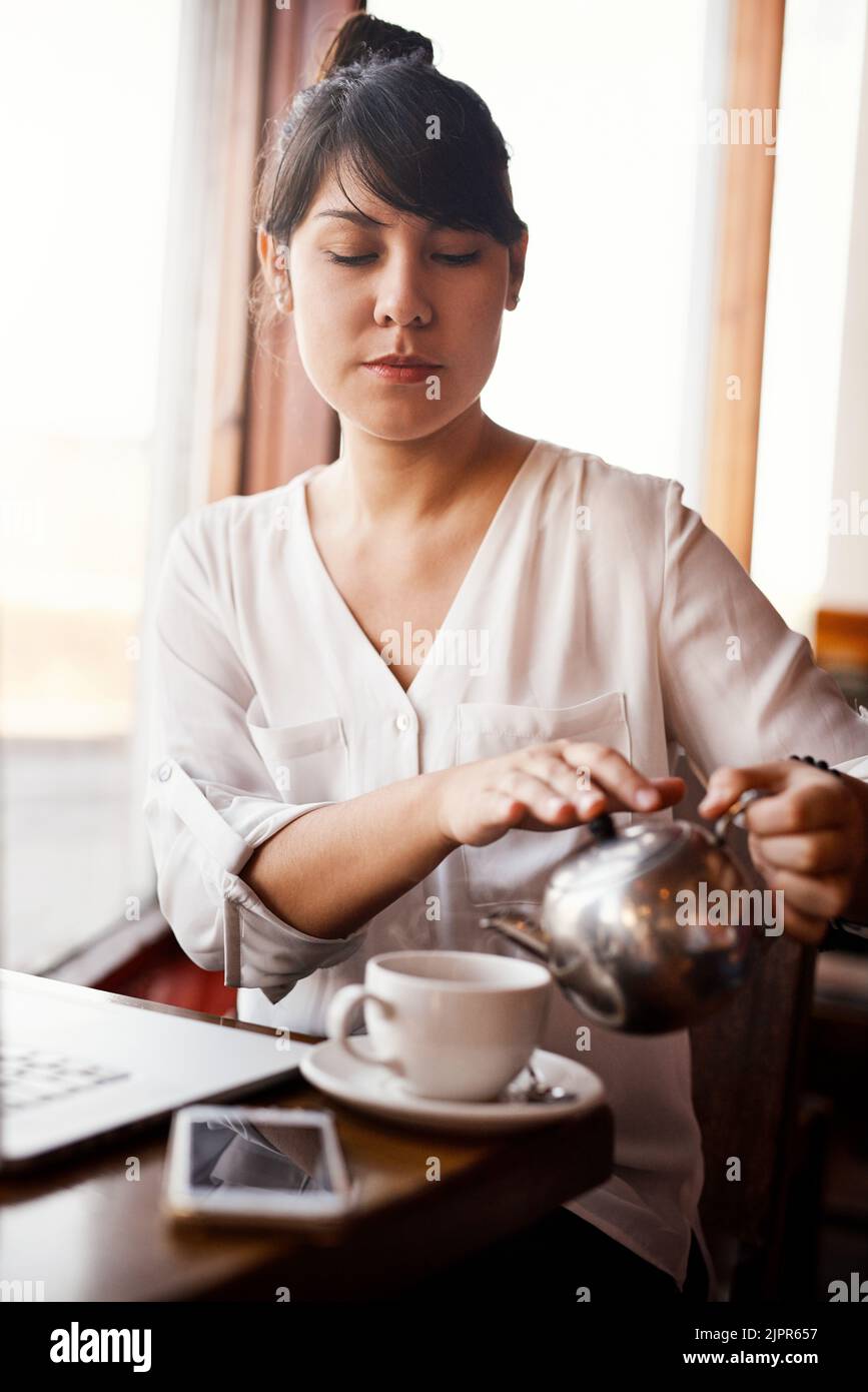 This is a daily ritual. a beautiful young woman drinking coffee at a ...
