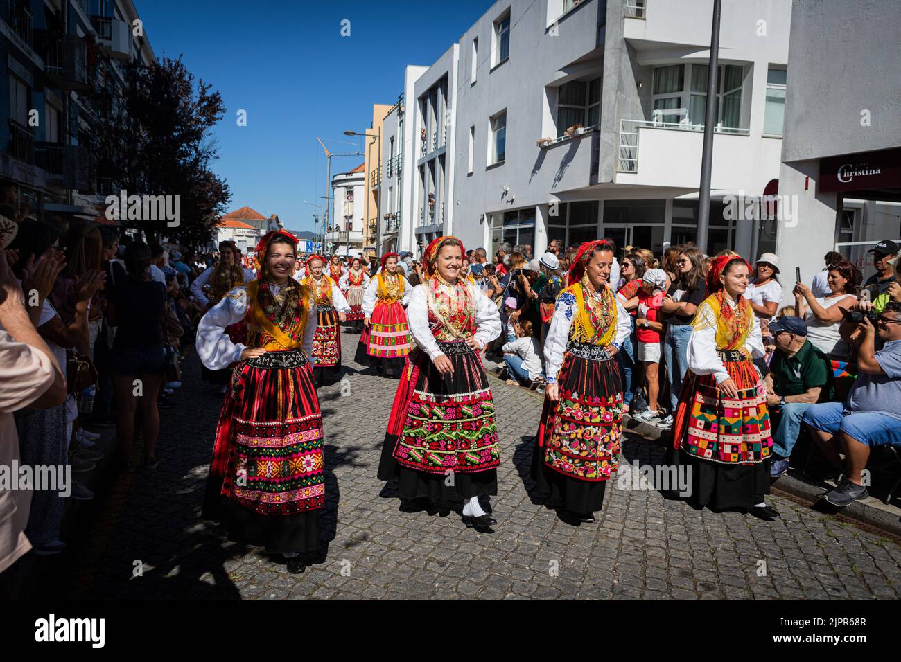 Women are seen walking the parade in traditional costumes. More than ...