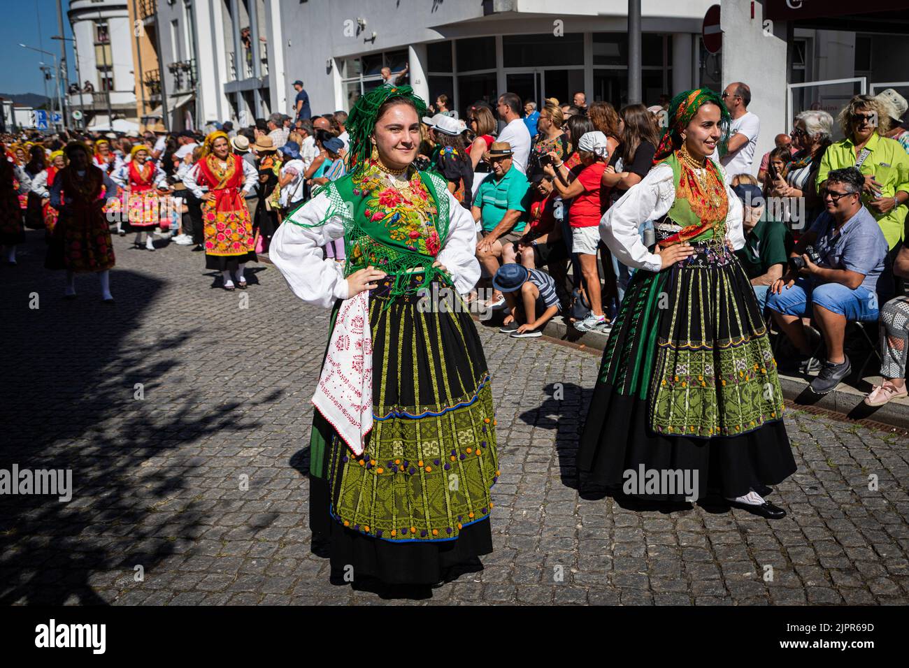 Women are seen walking the parade in traditional green costumes. More ...