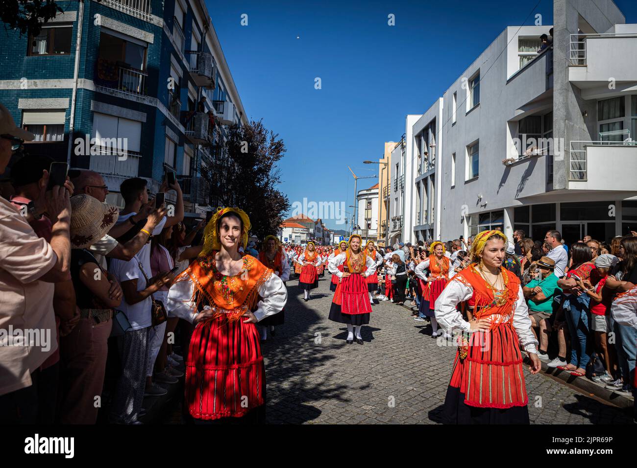 More than fifty women walked the parade wearing traditional red costume ...