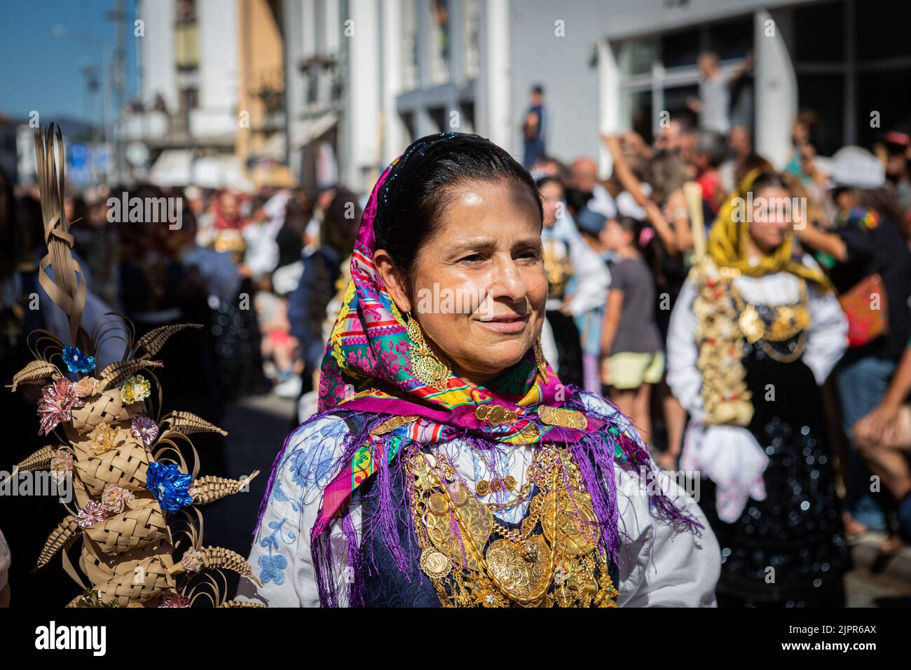 Portrait of a mordoma in purple with a palmito (the candle piece). More ...