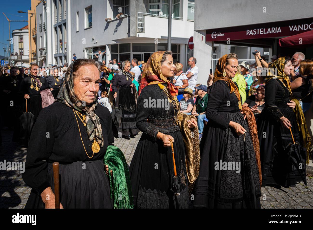 The mordomas walk the parade dressed in black and with much richer ...