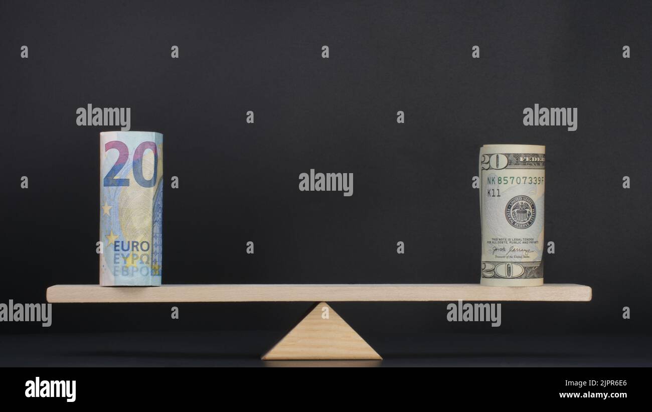 20 Euro and 20 USD equally balanced on a scale showing parity Stock ...