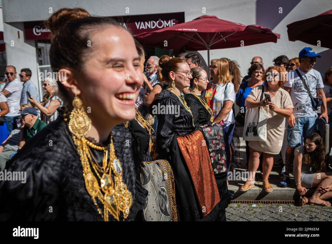 A mordoma laughs with the crowd while all the mordomas walk the parade ...