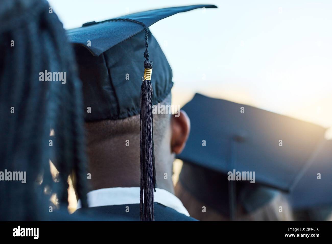 Time to step into a new world. Rearview shot of a group of students ...
