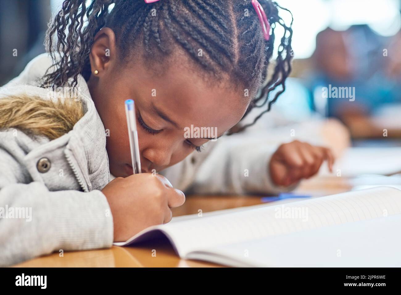 Focused on the task the teacher has given. an elementary school girl ...