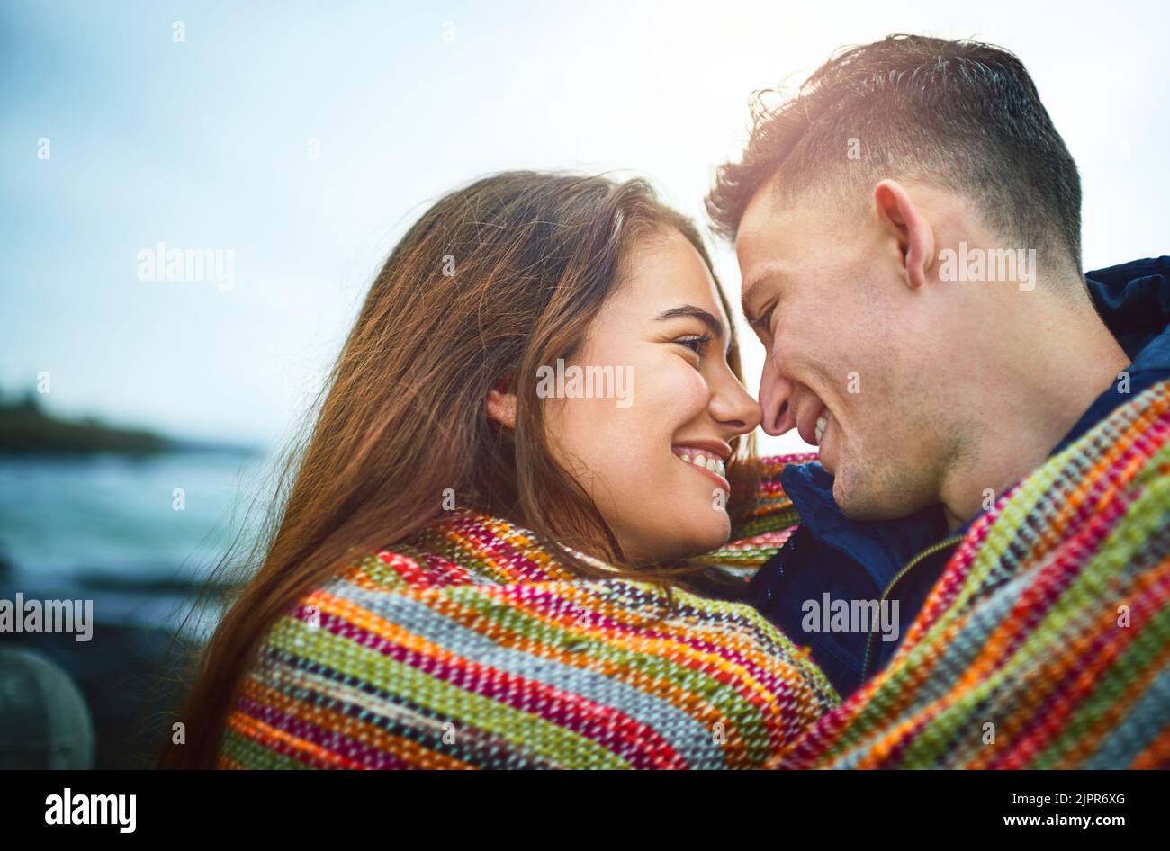 Cuddles Keep The Cold Away A Happy Young Couple Covering Themselves