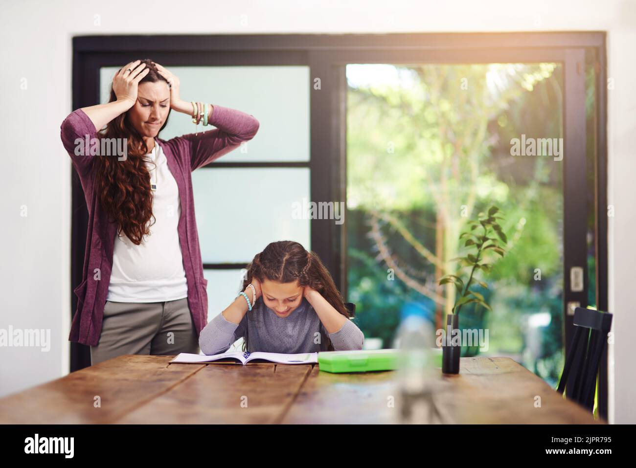 When you cant figure out the answer. a young girl doing homework with ...
