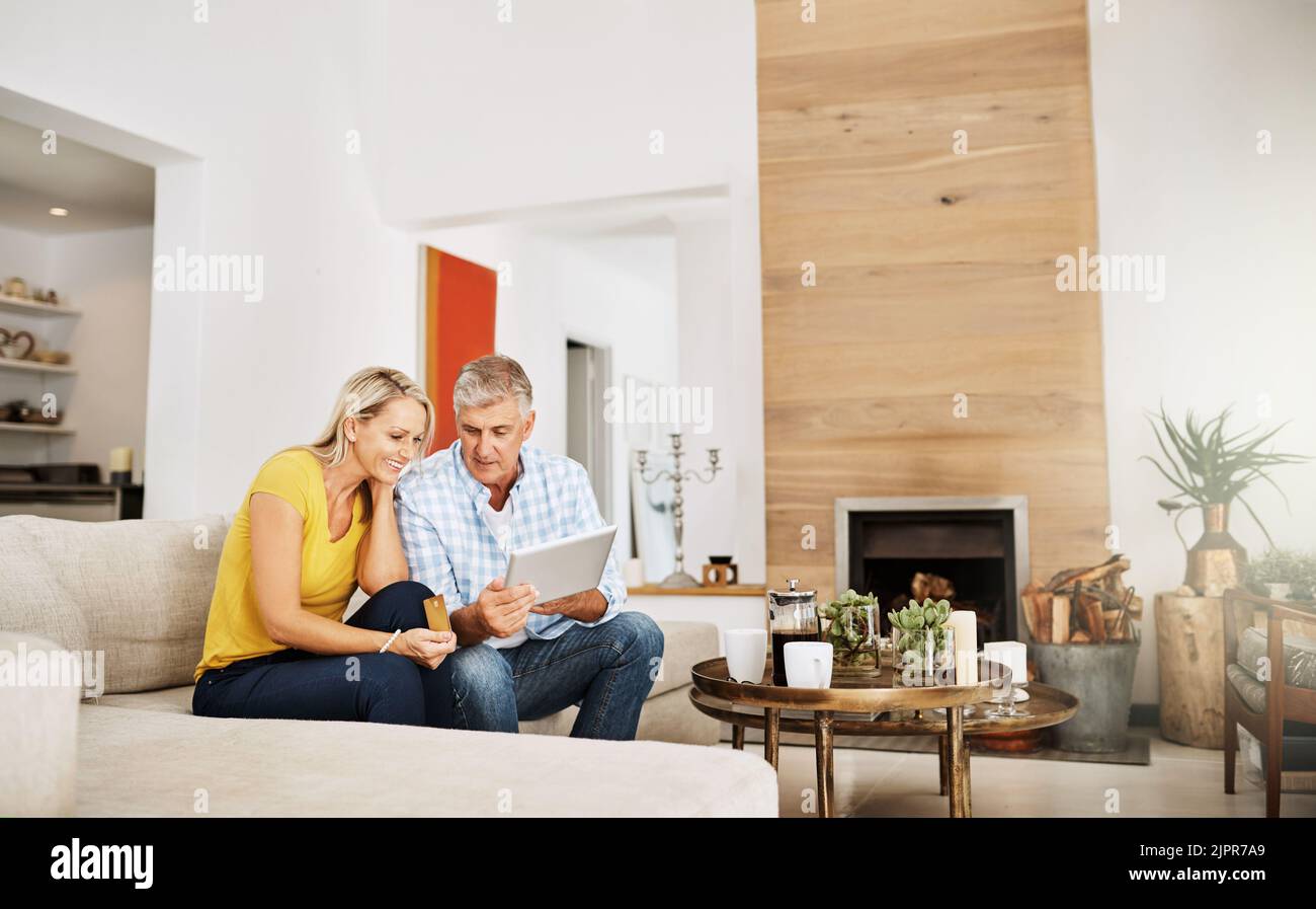 Buy whatever you like...a mature couple using a digital tablet while ...