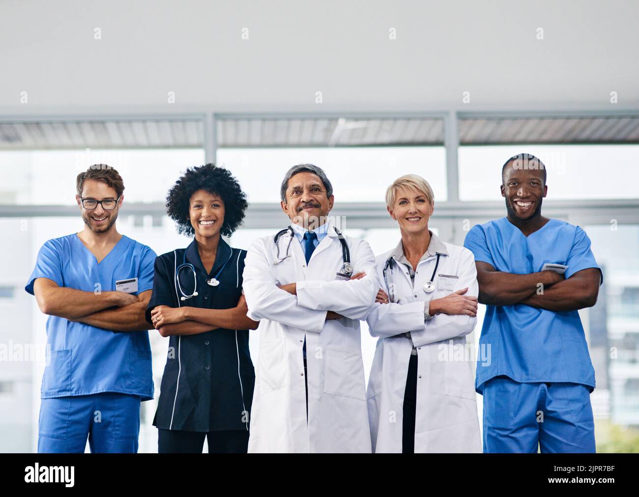 Your health is our priority. Portrait of a diverse team of doctors standing together in a ...