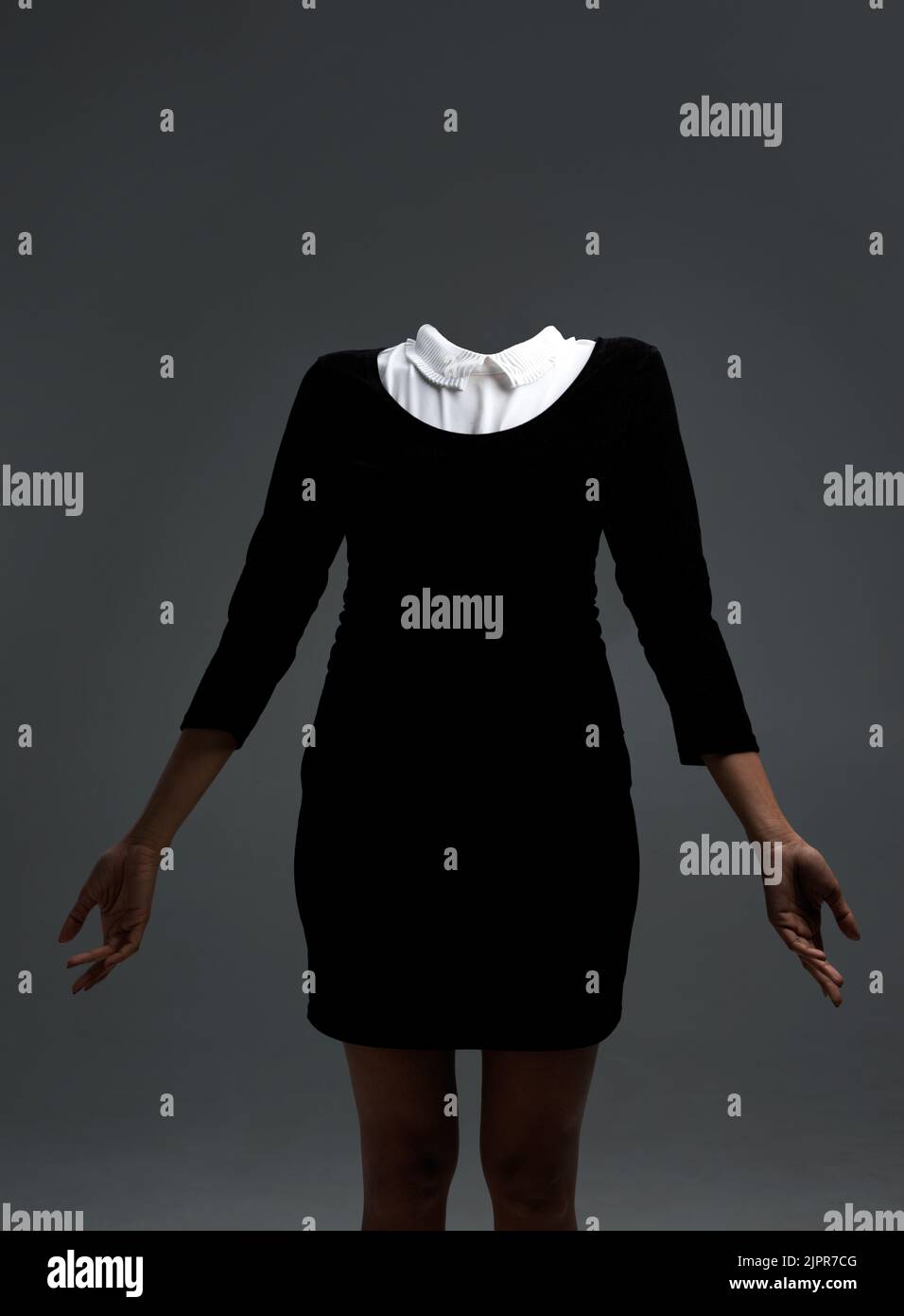What a scary sight. Studio shot of a headless woman against a grey ...