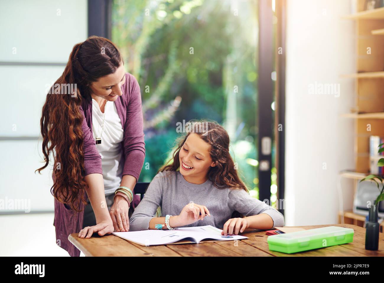 Great, you almost done with your homework. a young girl doing homework ...
